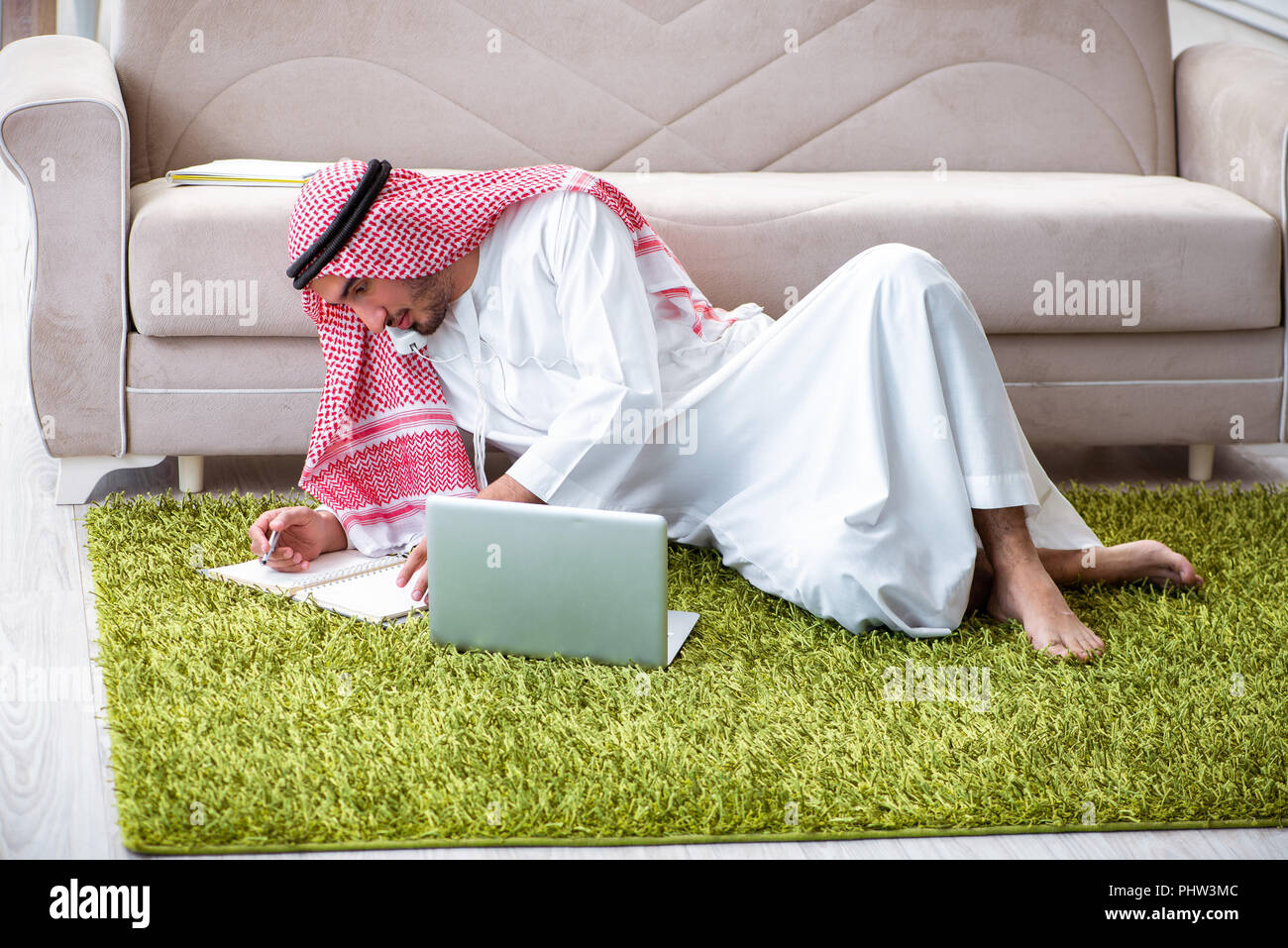 Arab man working at home on his work Stock Photo - Alamy
