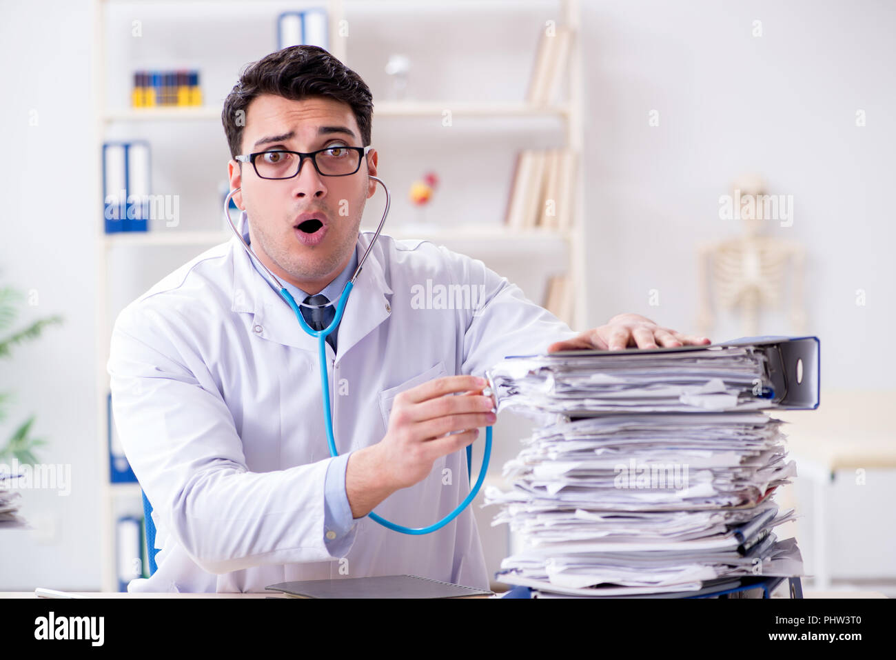 Busy doctor with too much work in hospital Stock Photo - Alamy