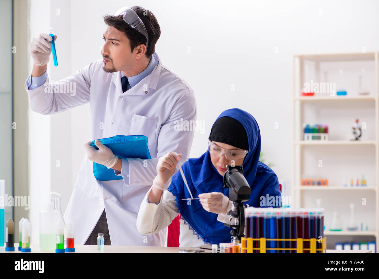 Diverse chemists working in laboratory hi-res stock photography and ...
