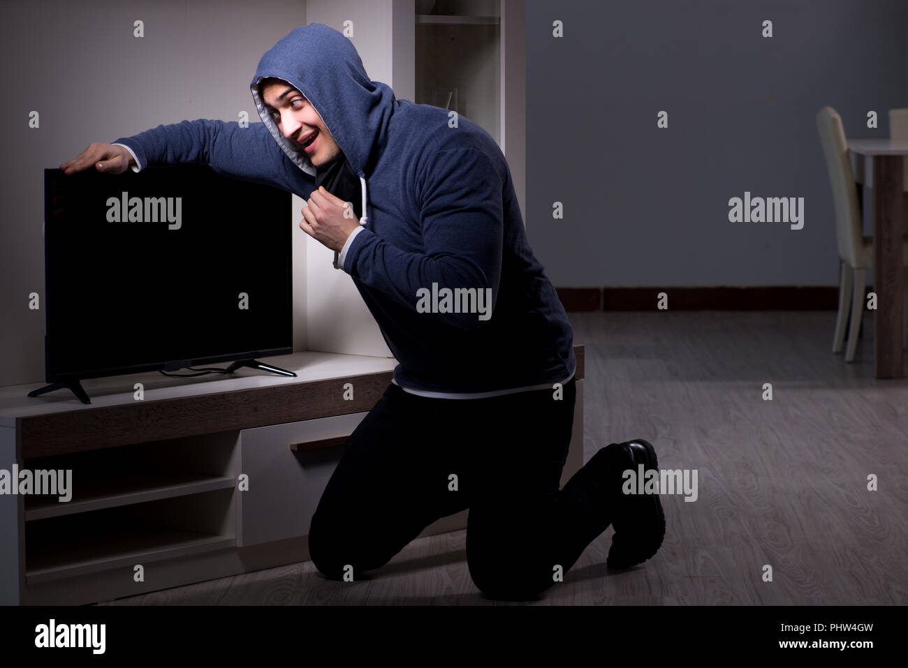 Burglar thief stealing tv from apartment house Stock Photo - Alamy