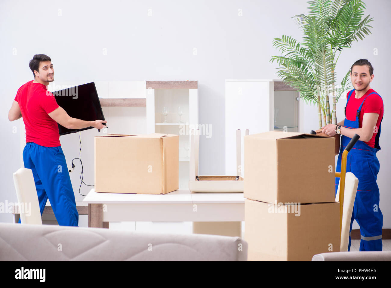 Two contractor employees moving personal belongings Stock Photo - Alamy