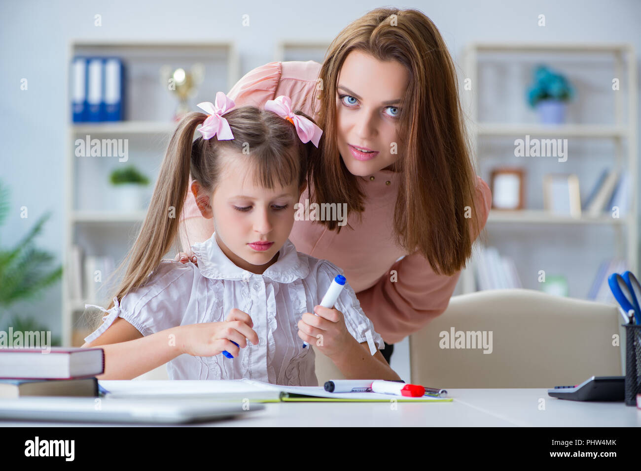 Mother helping her daughter to do homework Stock Photo - Alamy