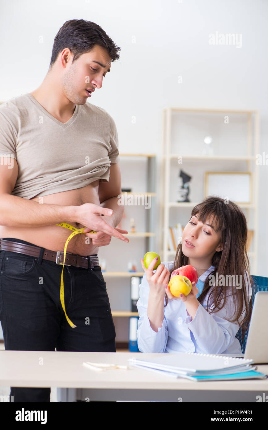 Doctor dietician giving advices to fat overweight patient Stock Photo ...
