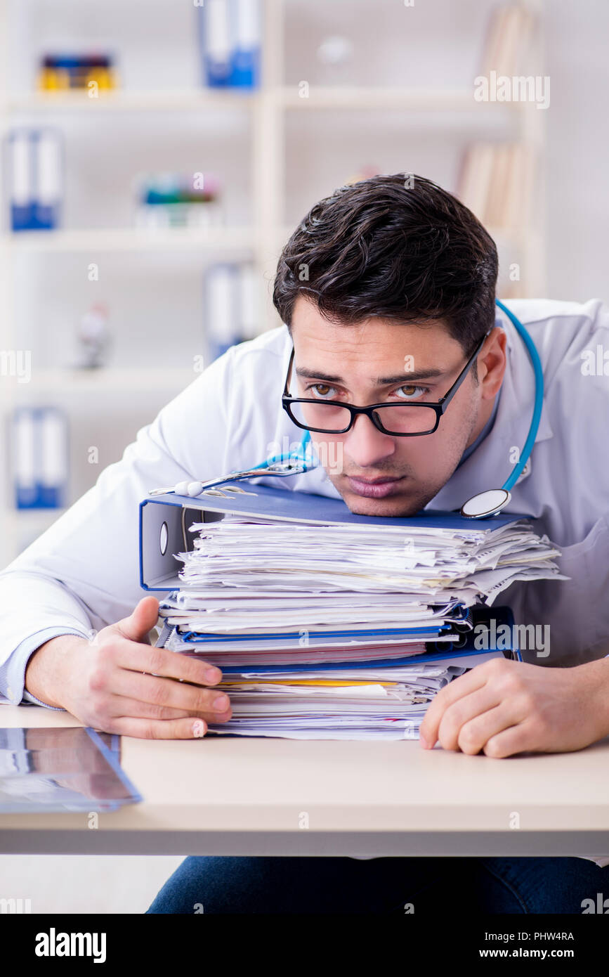 Busy doctor with too much work in hospital Stock Photo - Alamy