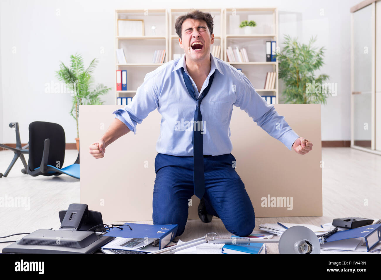 Angry businessman frustrated with too much work Stock Photo - Alamy