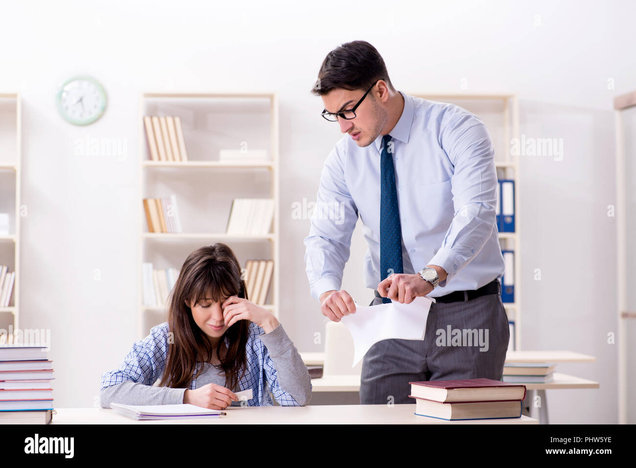 Male lecturer giving lecture to female student Stock Photo - Alamy