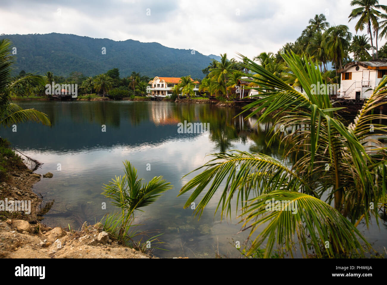 Lake in the subtropics, with houses in the background Stock Photo - Alamy