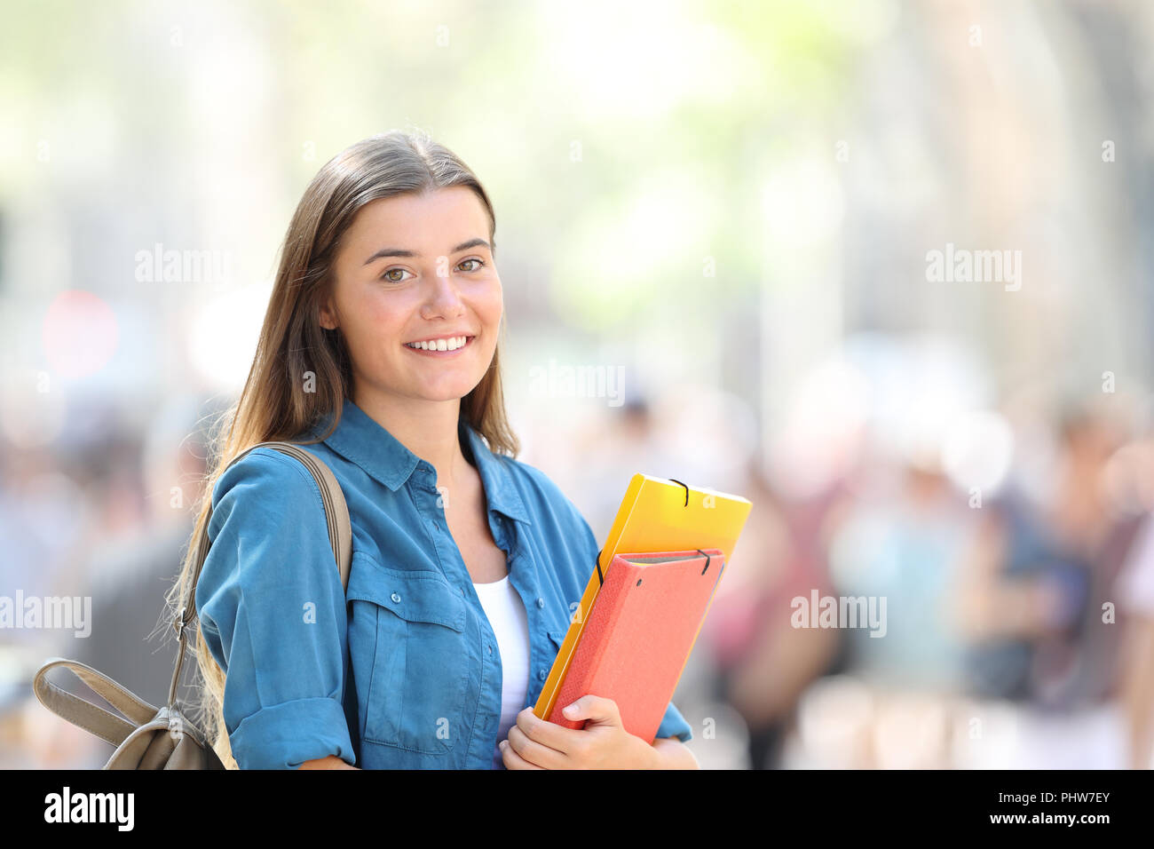 Happy student posing smiling and looking at camera in the street Stock ...