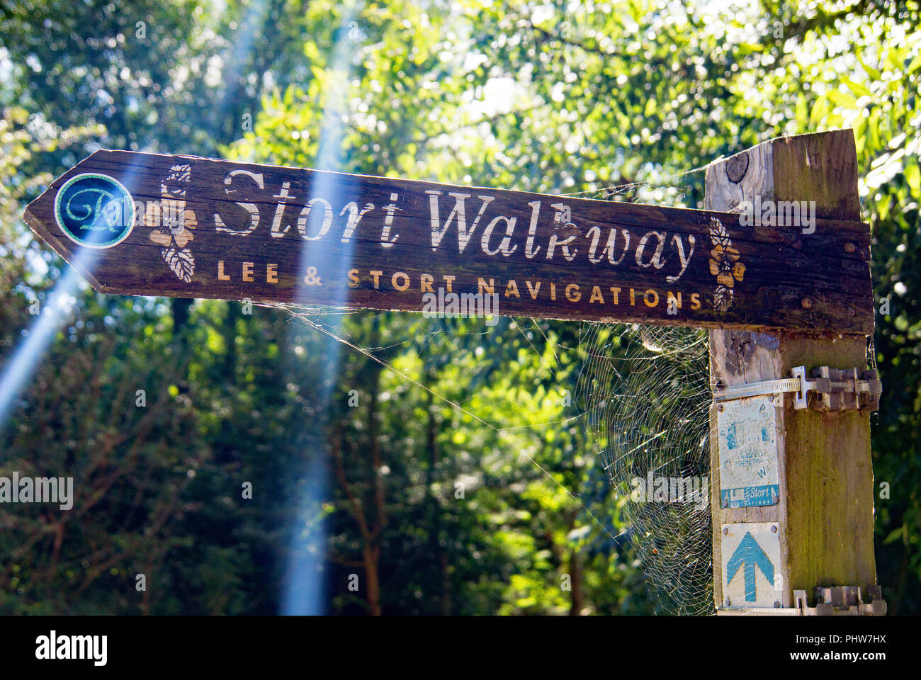 A sign under a sunlit tree canopy showing the route of the Stort ...
