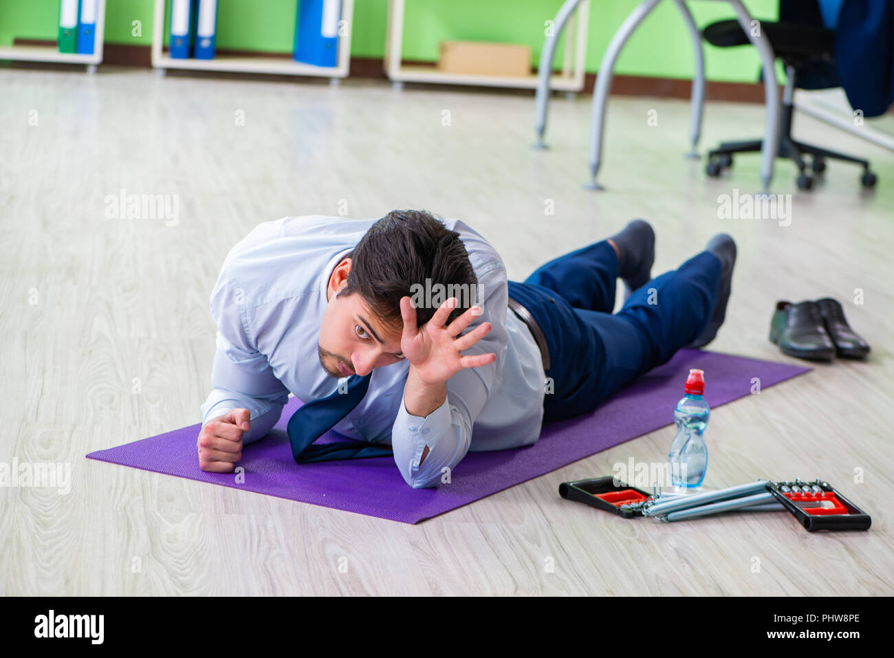 Employee doing exercises during break at work Stock Photo - Alamy