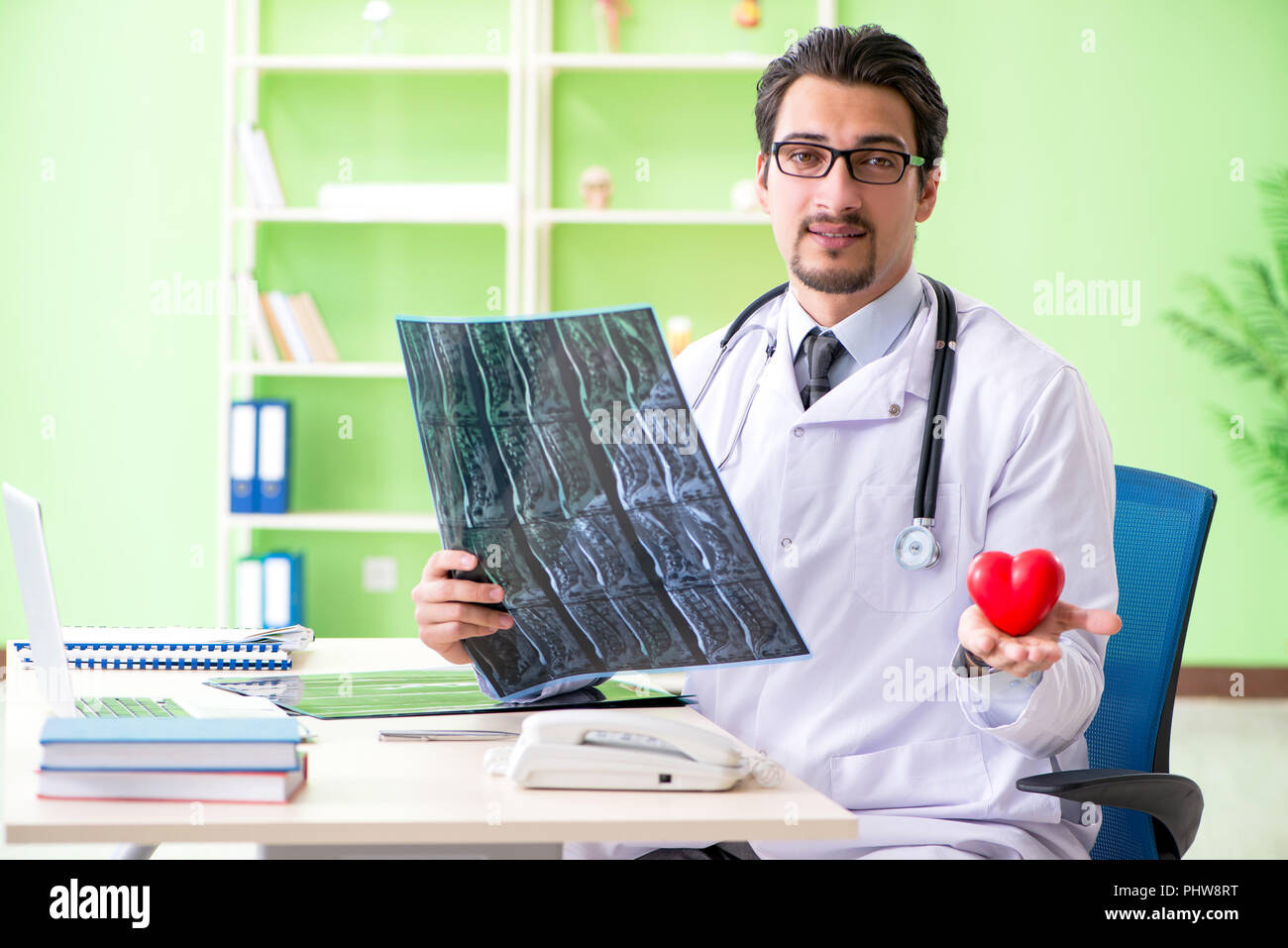 Doctor radiologist looking at x-ray scan in hospital Stock Photo - Alamy