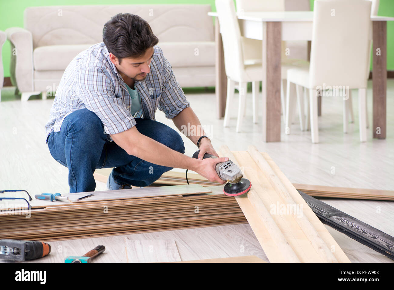 Man laying flooring at home Stock Photo - Alamy