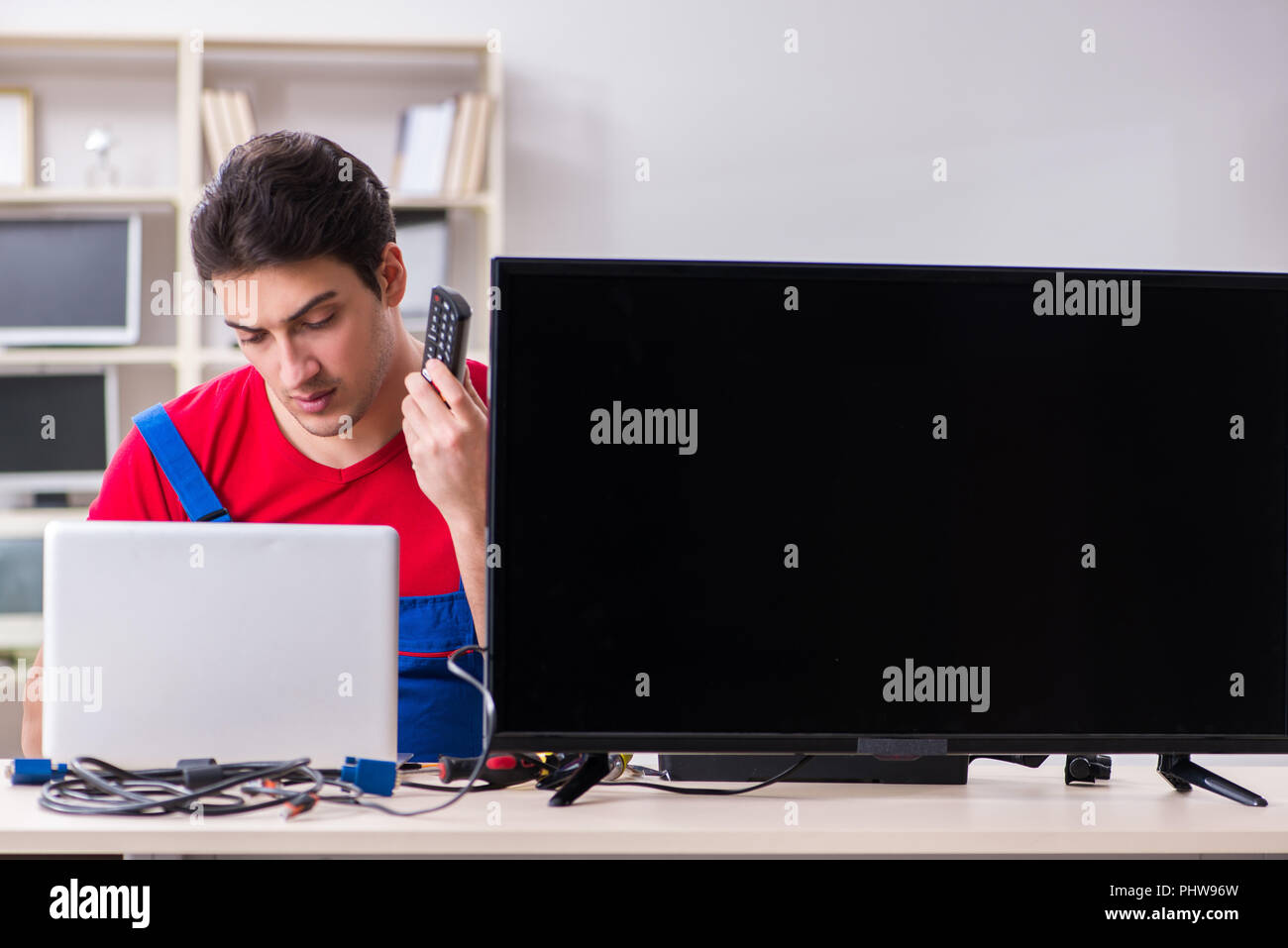 Professional repair engineer repairing broken tv Stock Photo - Alamy