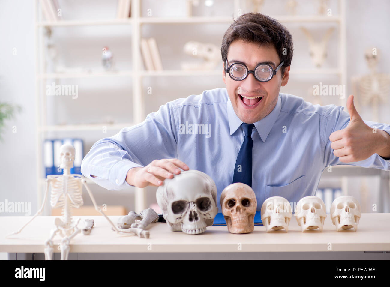 Funny crazy professor studying human skeleton Stock Photo - Alamy