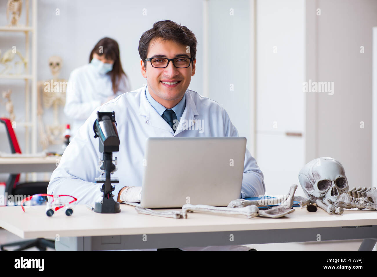 Professor studying human skeleton in lab Stock Photo - Alamy