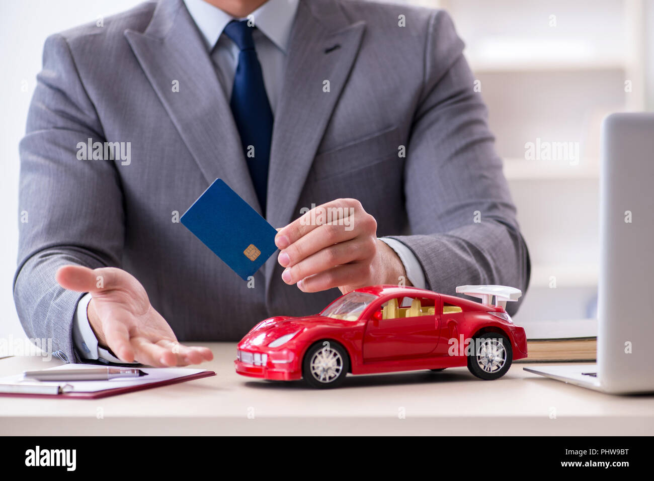 Agent offering car motor insurance Stock Photo - Alamy