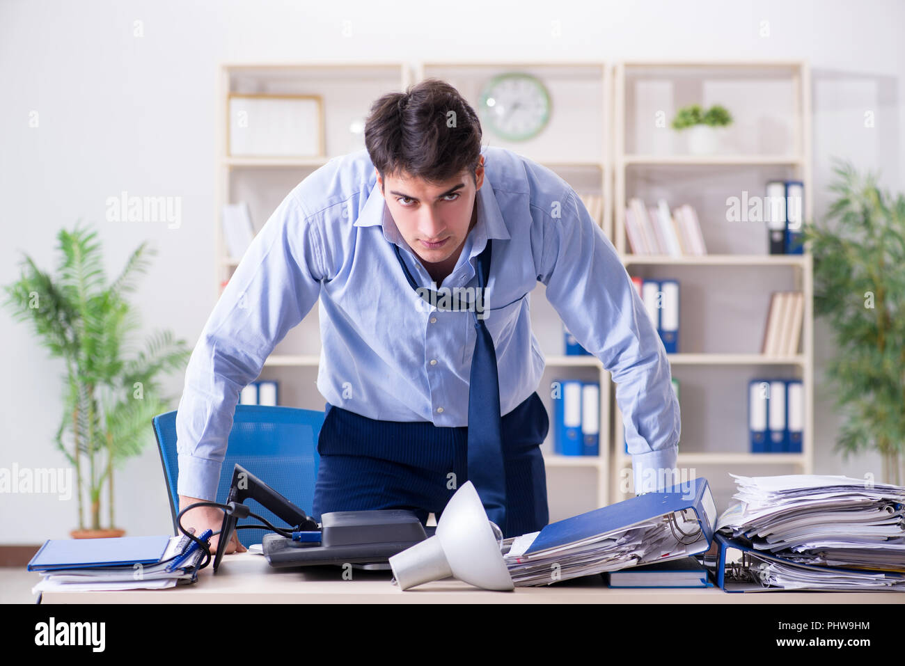 Angry businessman frustrated with too much work Stock Photo - Alamy