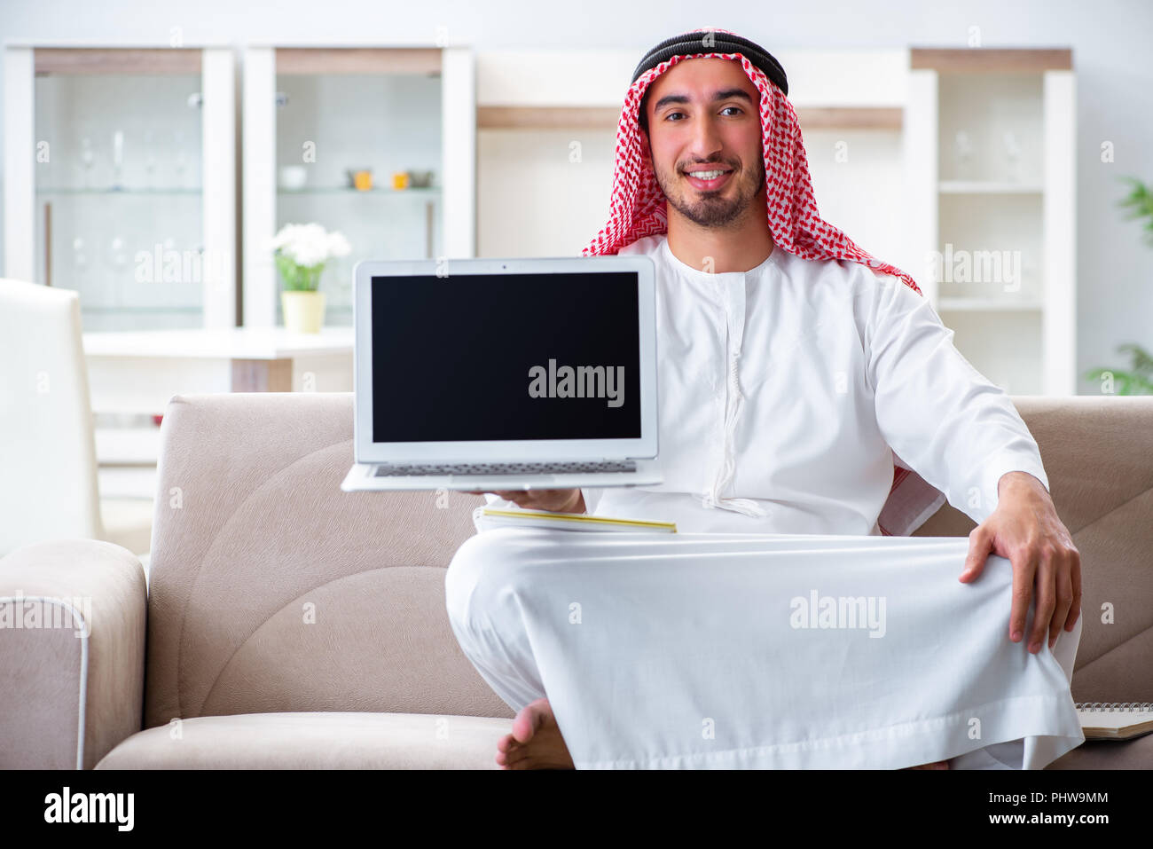 Arab man working at home on his work Stock Photo - Alamy