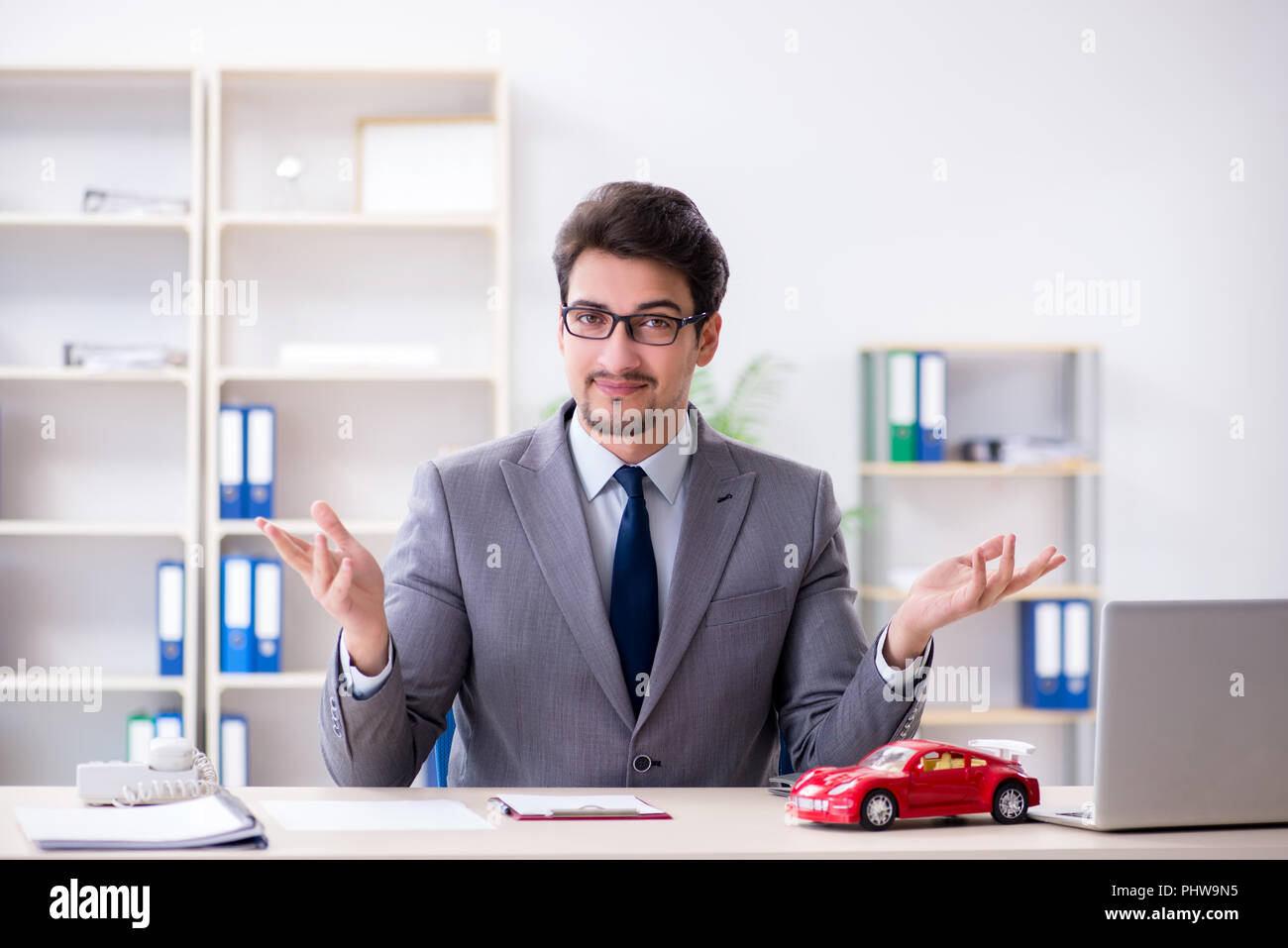 Agent offering car motor insurance Stock Photo - Alamy