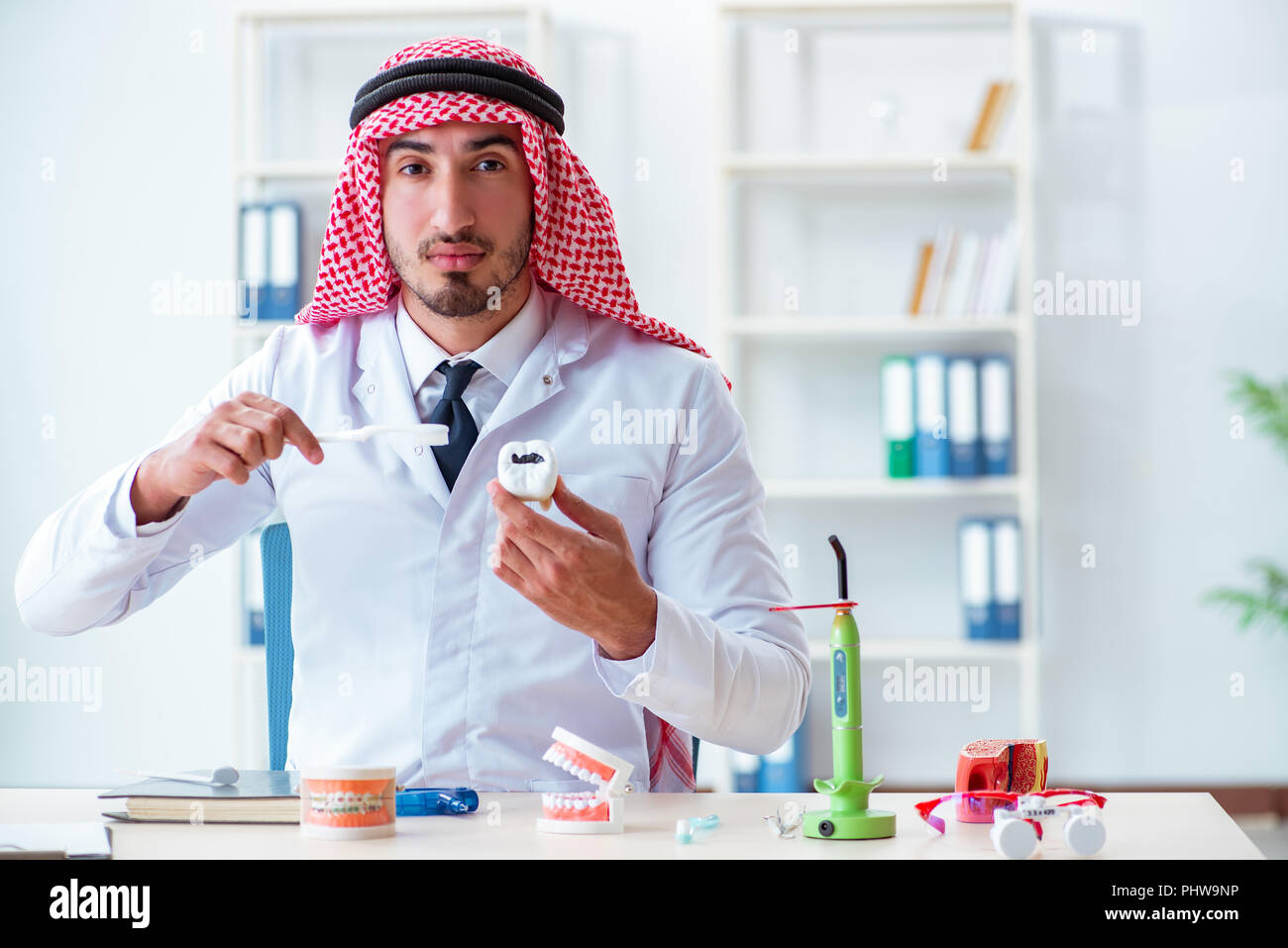 Arab dentist working on new teeth implant Stock Photo - Alamy