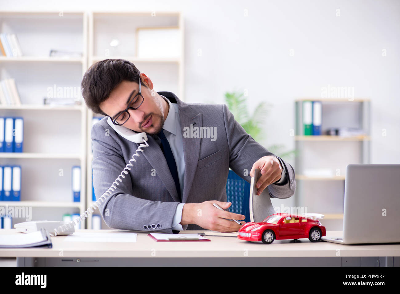 Agent offering car motor insurance Stock Photo - Alamy