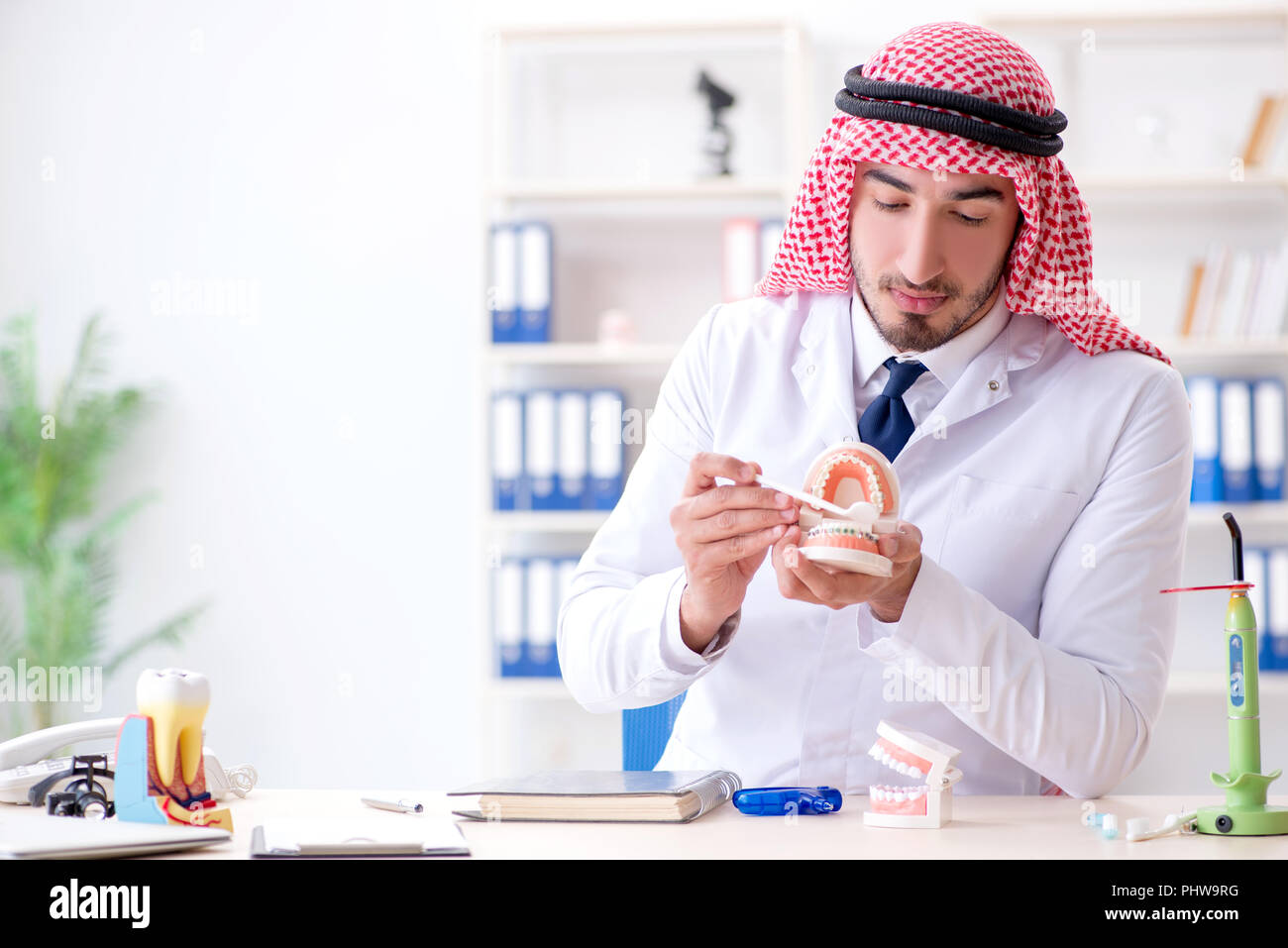 Arab dentist working on new teeth implant Stock Photo - Alamy