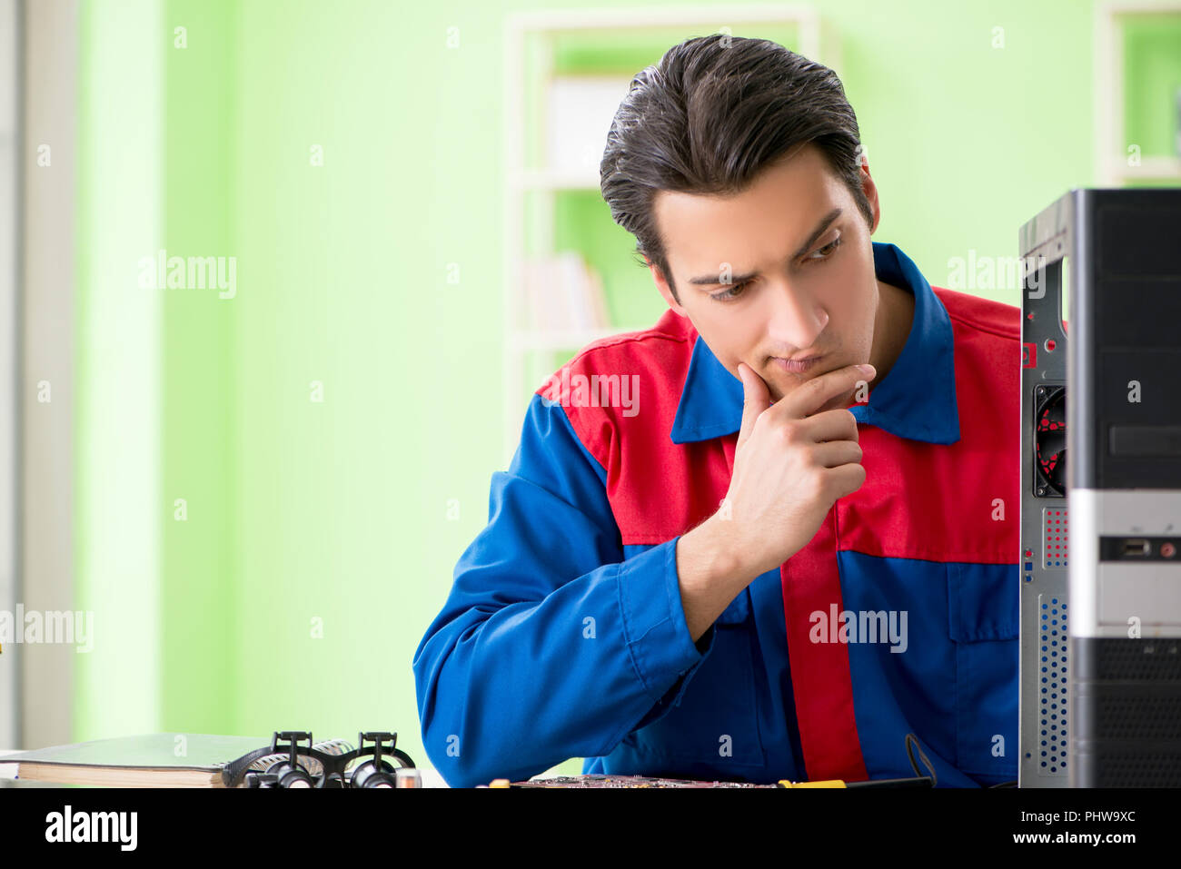 Computer engineer repairing broken desktop Stock Photo - Alamy