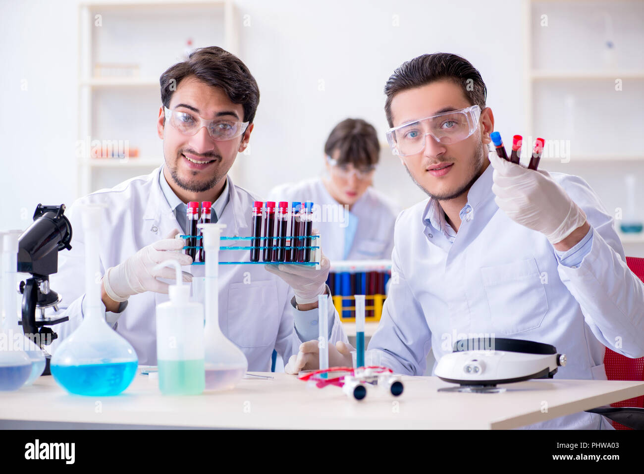 Team of chemists working in the lab Stock Photo - Alamy