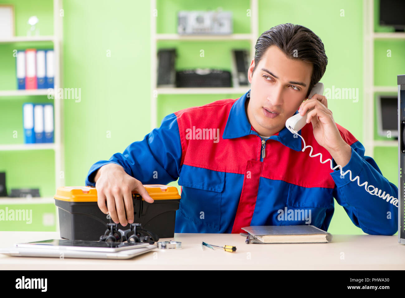 Computer engineer repairing broken desktop Stock Photo - Alamy