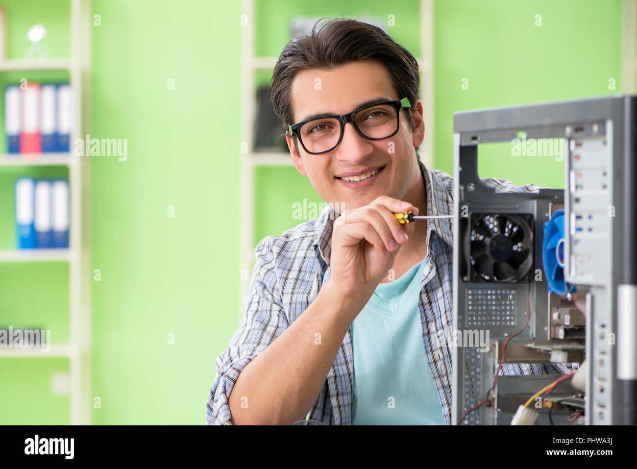 Computer engineer repairing broken desktop Stock Photo - Alamy