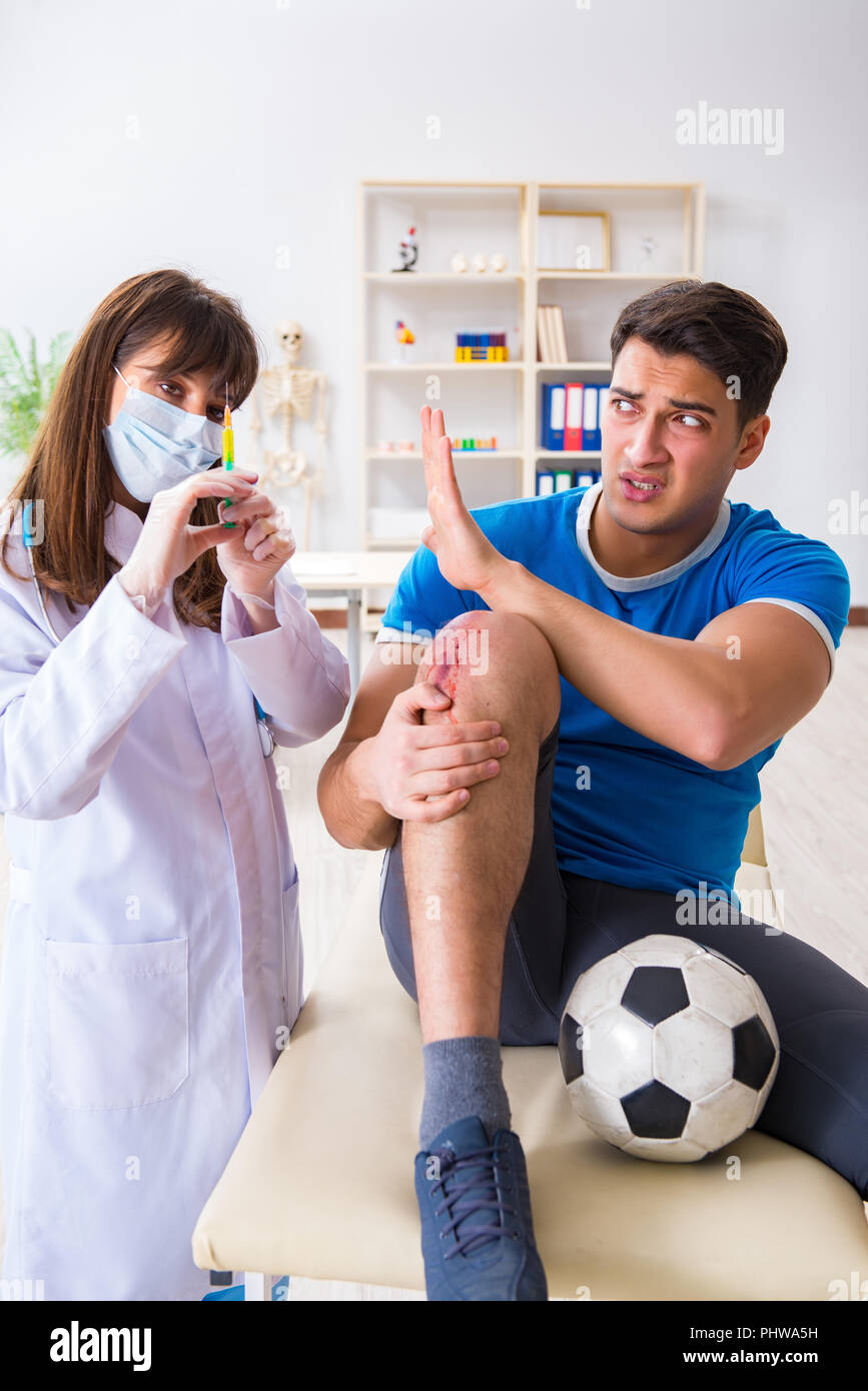 Football soccer player visiting doctor after injury Stock Photo - Alamy