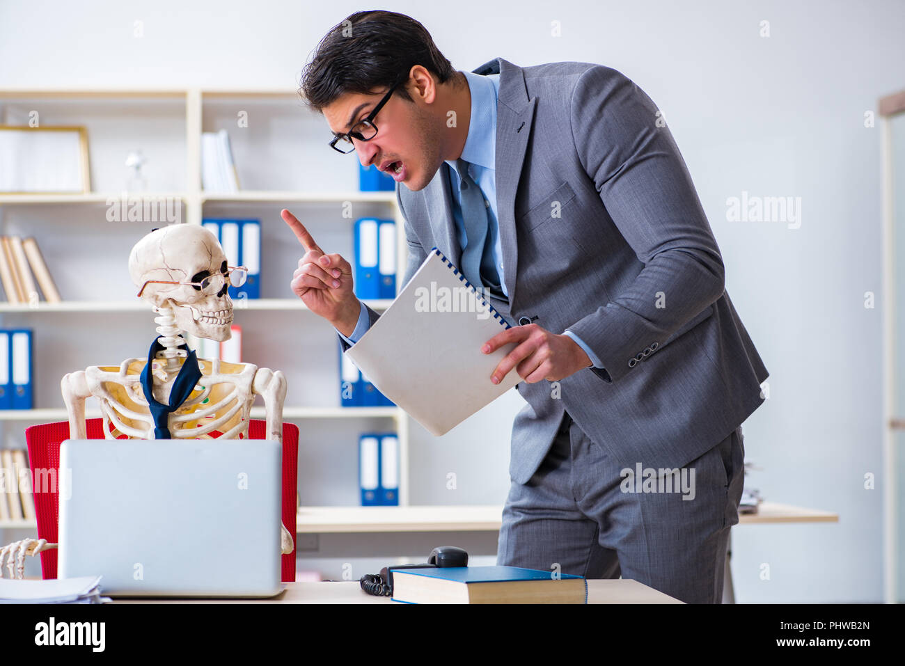 Angry boss yelling at his skeleton employee Stock Photo - Alamy