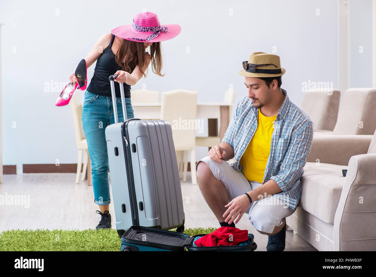 Young family packing for vacation travel Stock Photo - Alamy