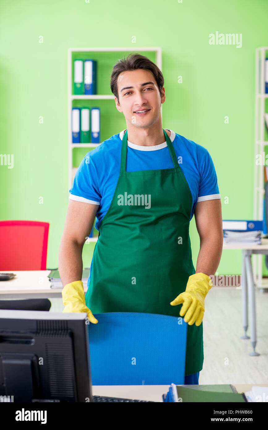 Male handsome professional cleaner working in the office Stock Photo ...