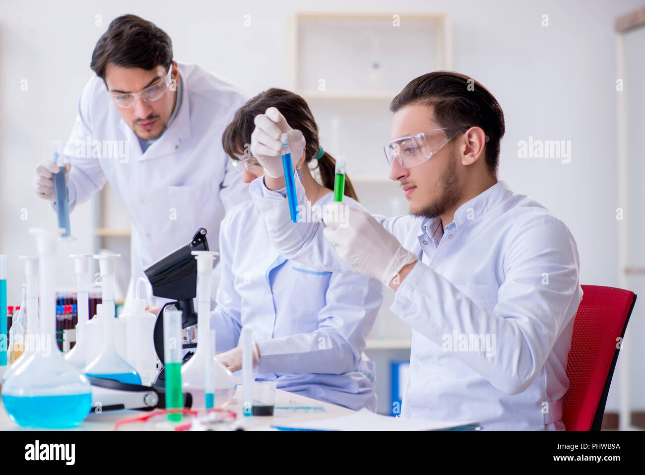 Team of chemists working in the lab Stock Photo - Alamy