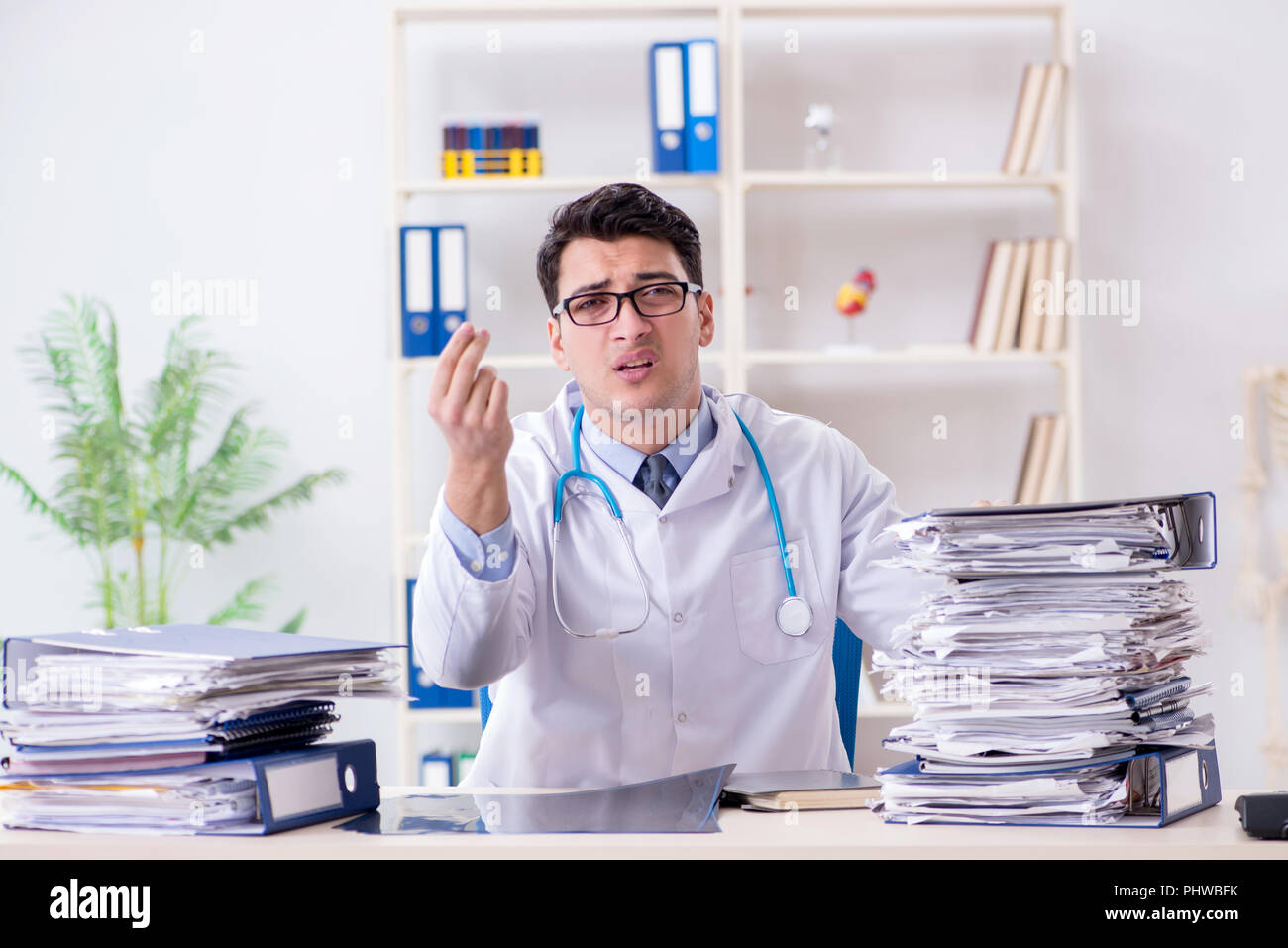 Busy doctor with too much work in hospital Stock Photo - Alamy