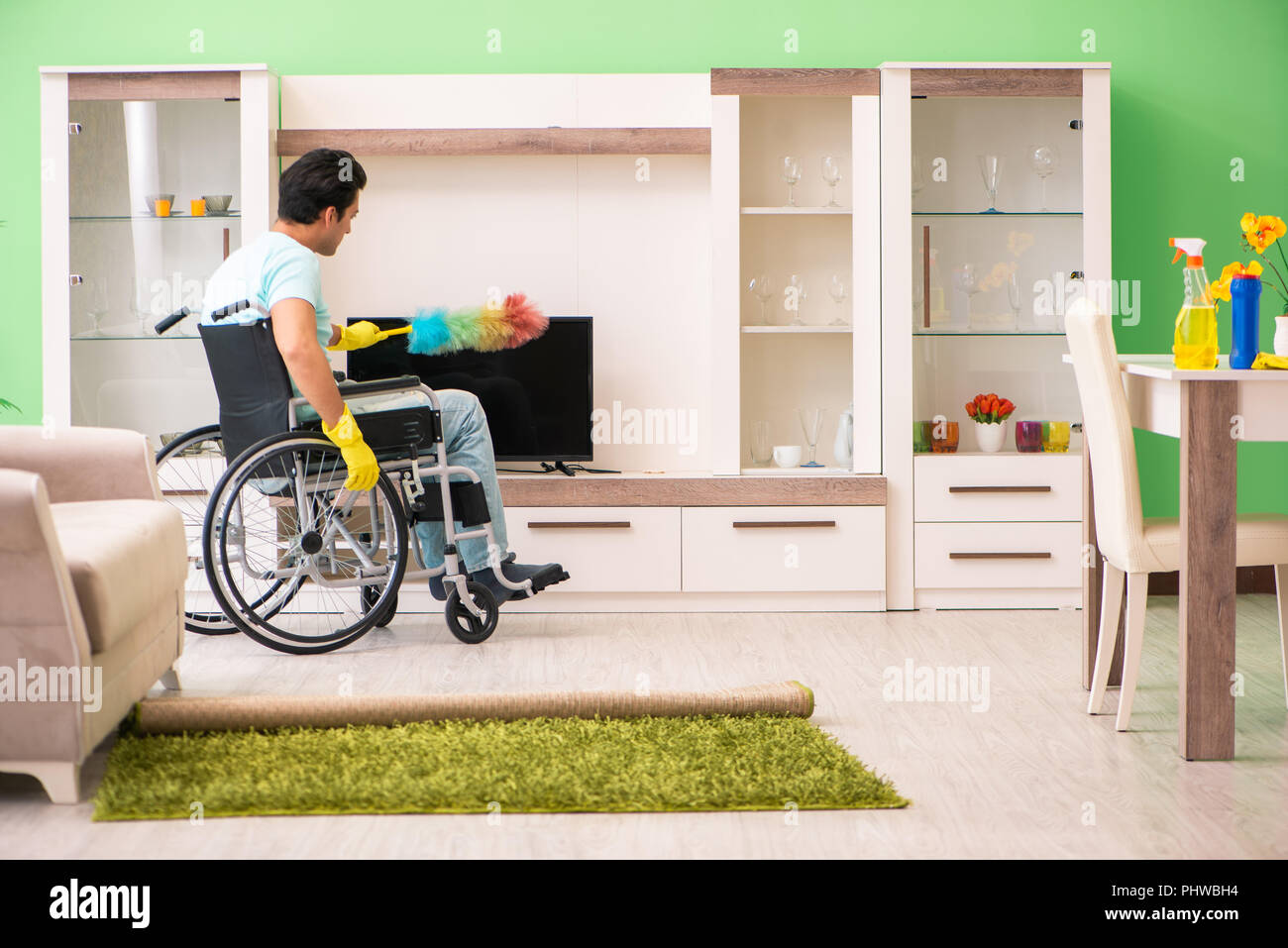 Disabled man on wheelchair cleaning house Stock Photo - Alamy