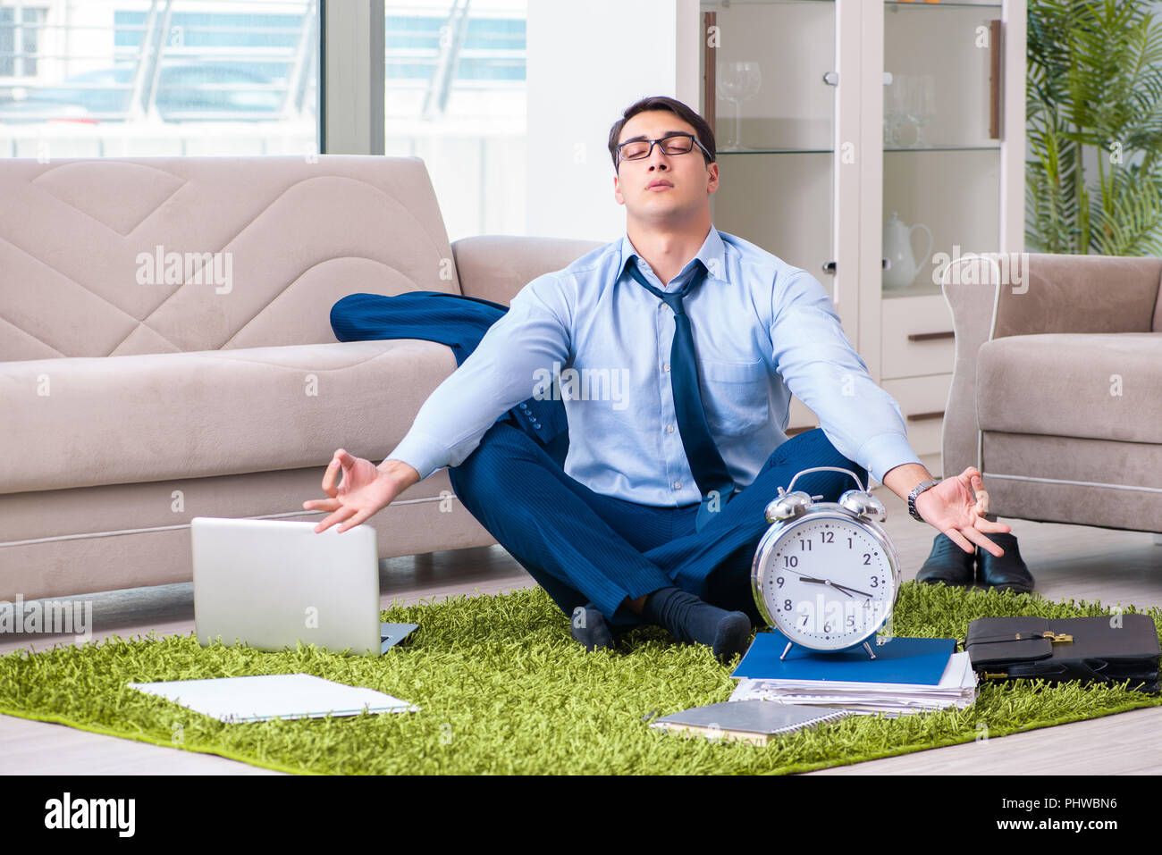 Businessman taking work home and working overtime Stock Photo - Alamy