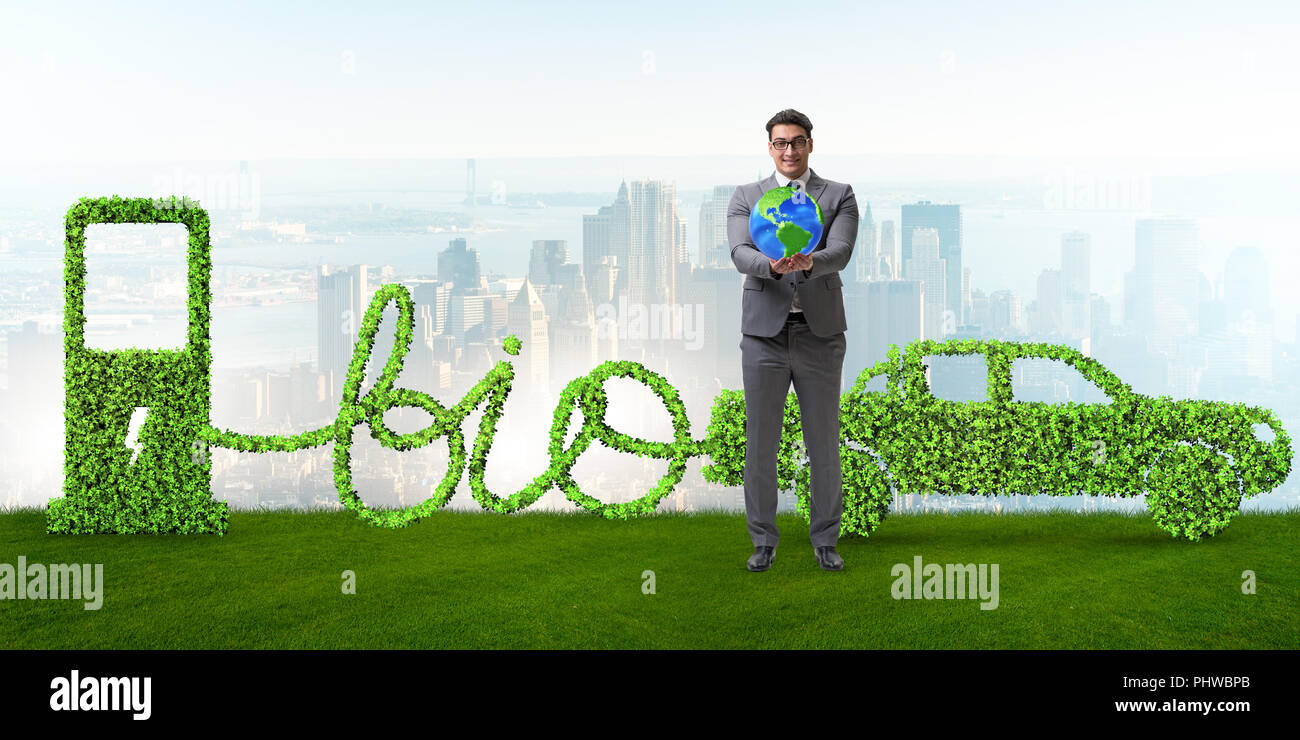 Businessman with car powered with biofuel Stock Photo - Alamy