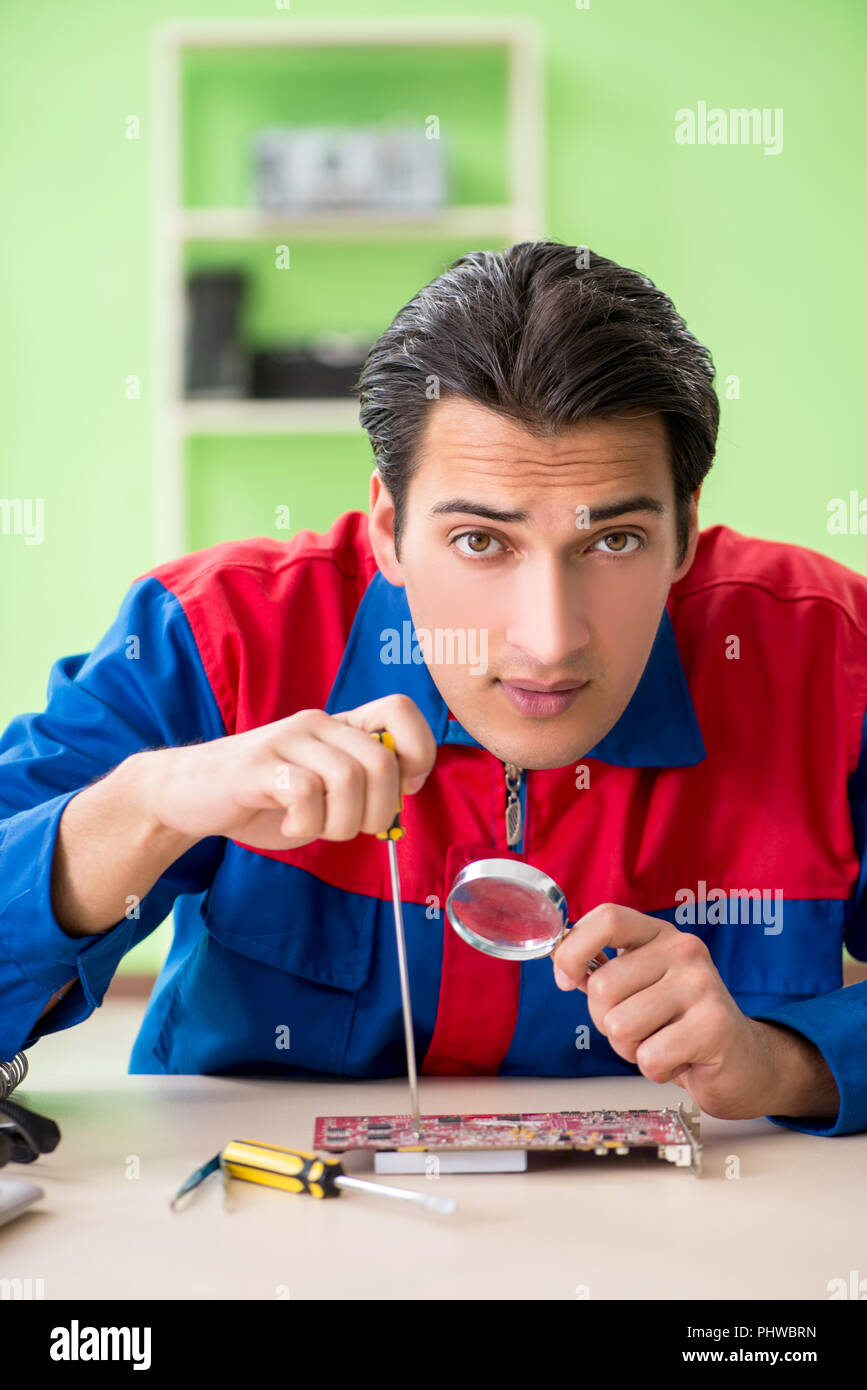 Computer engineer repairing broken desktop Stock Photo - Alamy