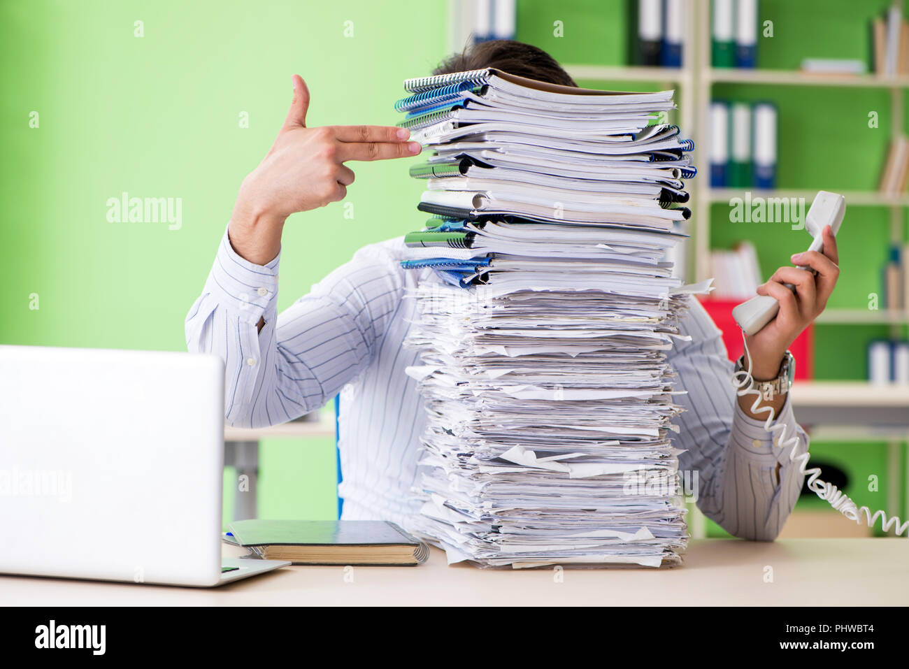 Businessman having problems with paperwork and workload Stock Photo - Alamy