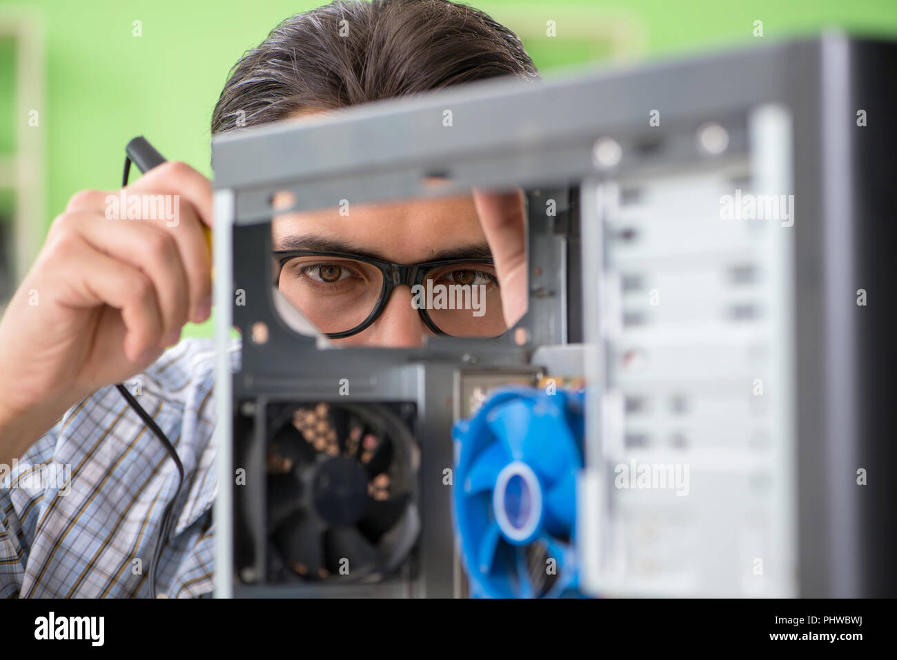 Computer engineer repairing broken desktop Stock Photo - Alamy