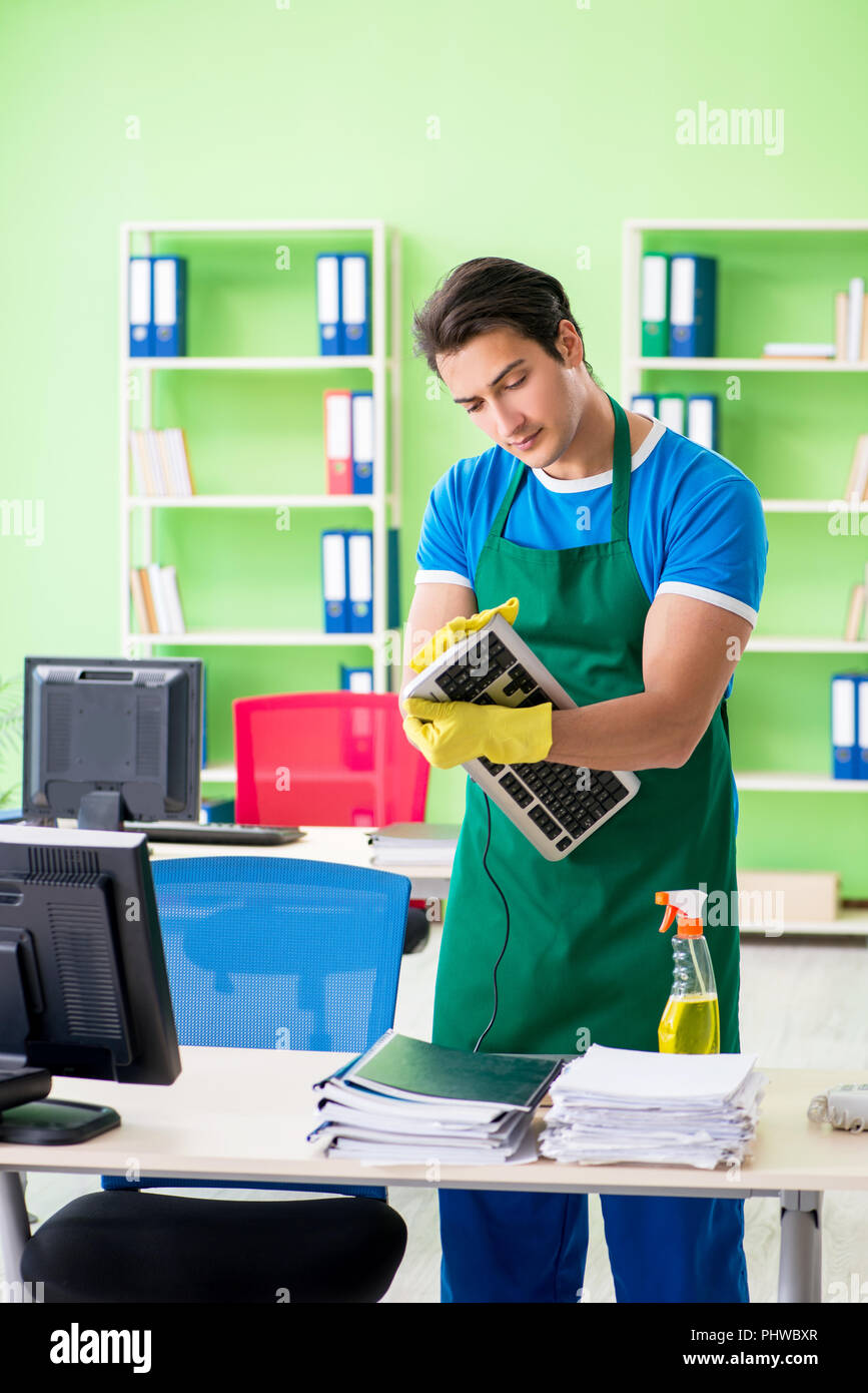 Male handsome professional cleaner working in the office Stock Photo ...