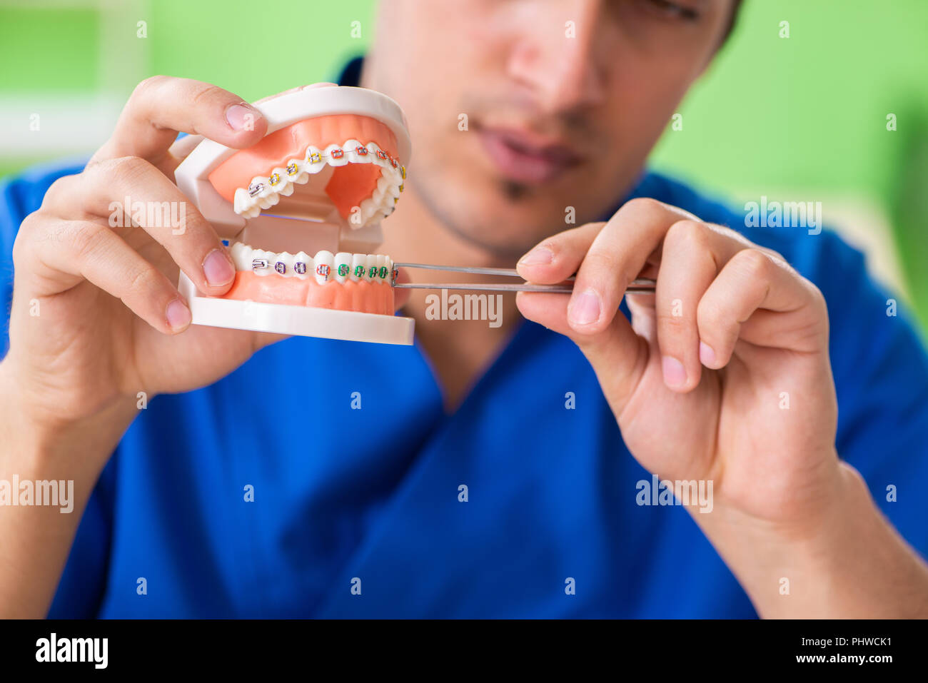 Man dentist working on new teeth implant Stock Photo - Alamy