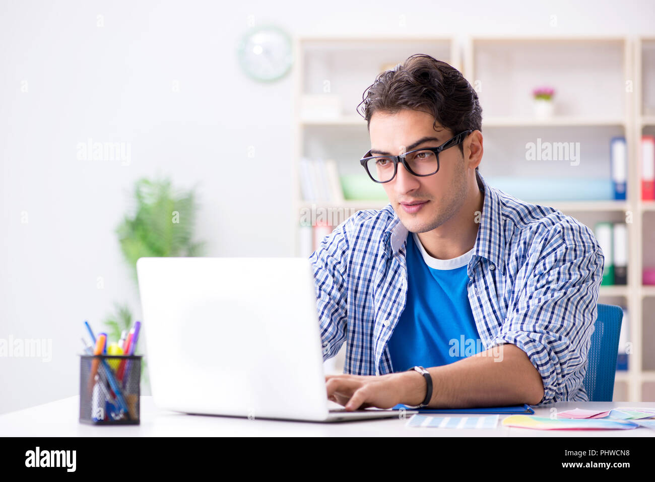 Young designer working on new project and choosing colours Stock Photo ...