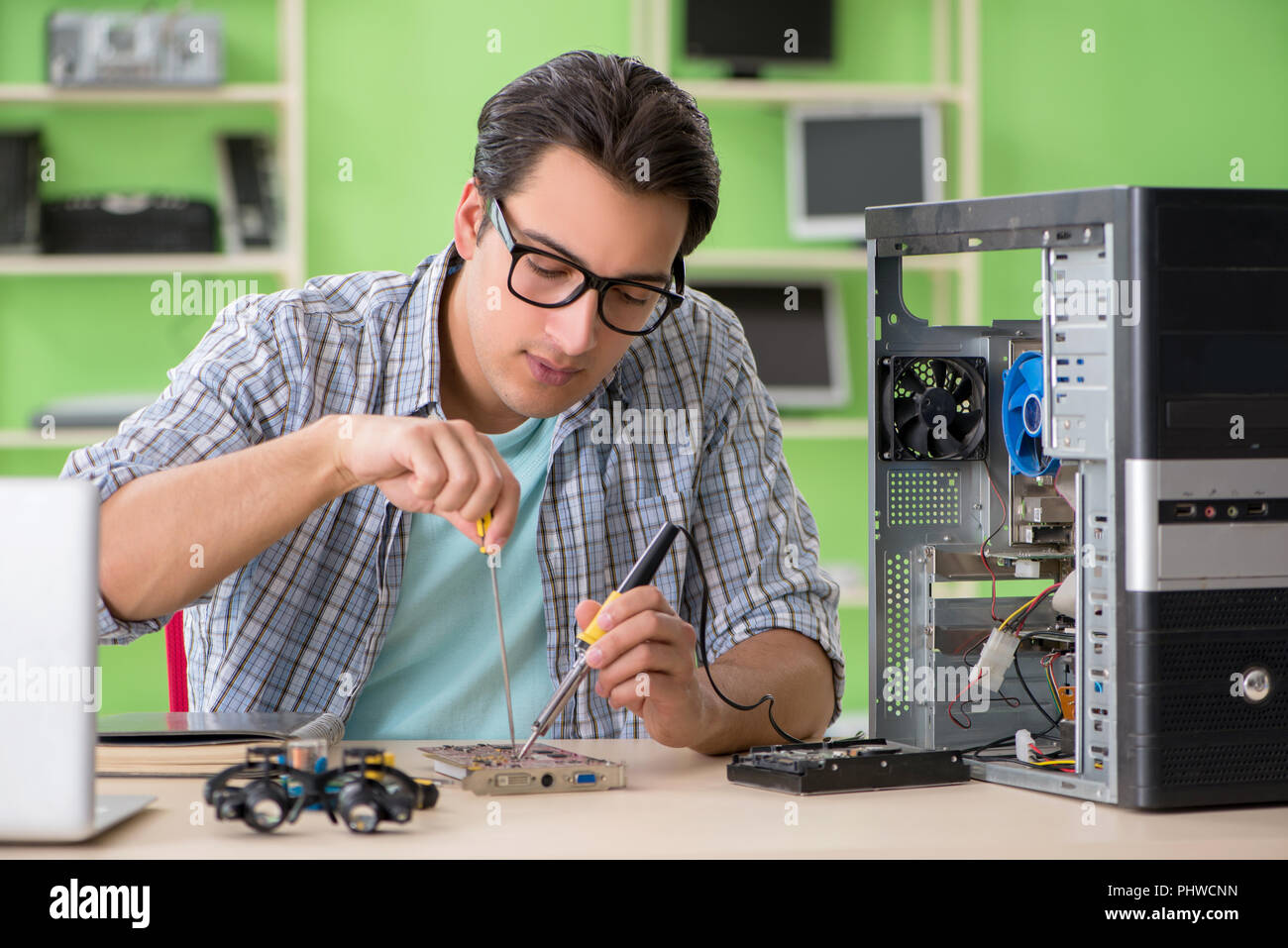 Computer engineer repairing broken desktop Stock Photo - Alamy