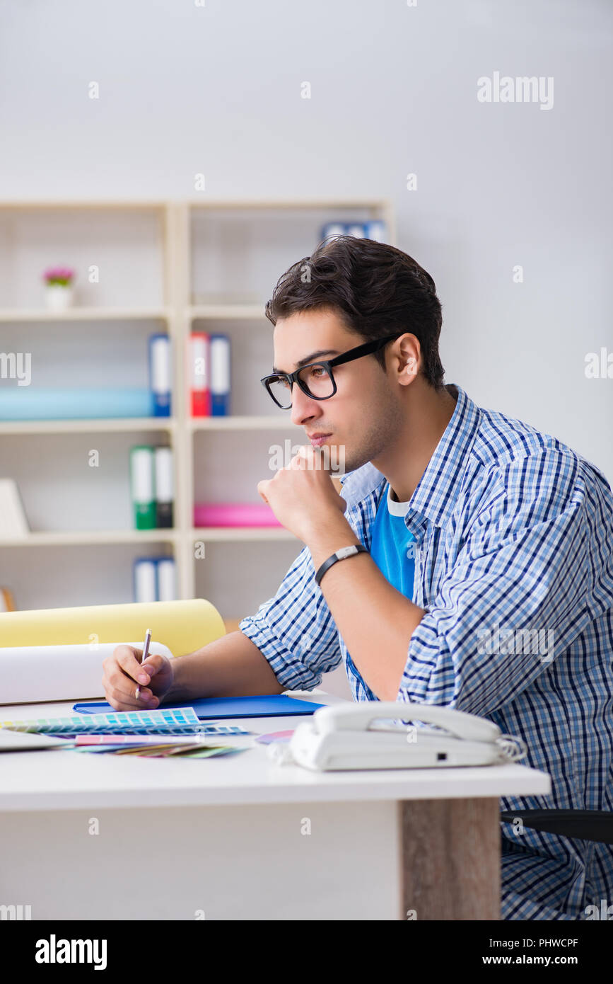 Young designer working on new project and choosing colours Stock Photo ...