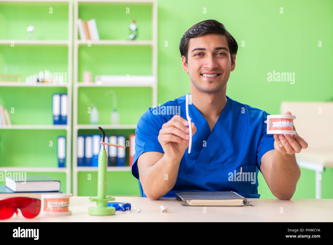 Man dentist working on new teeth implant Stock Photo - Alamy
