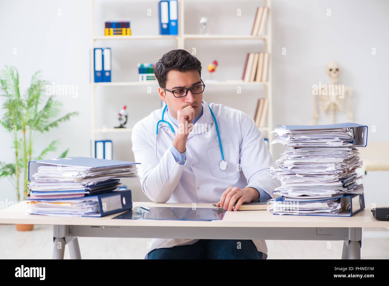 Busy doctor with too much work in hospital Stock Photo - Alamy