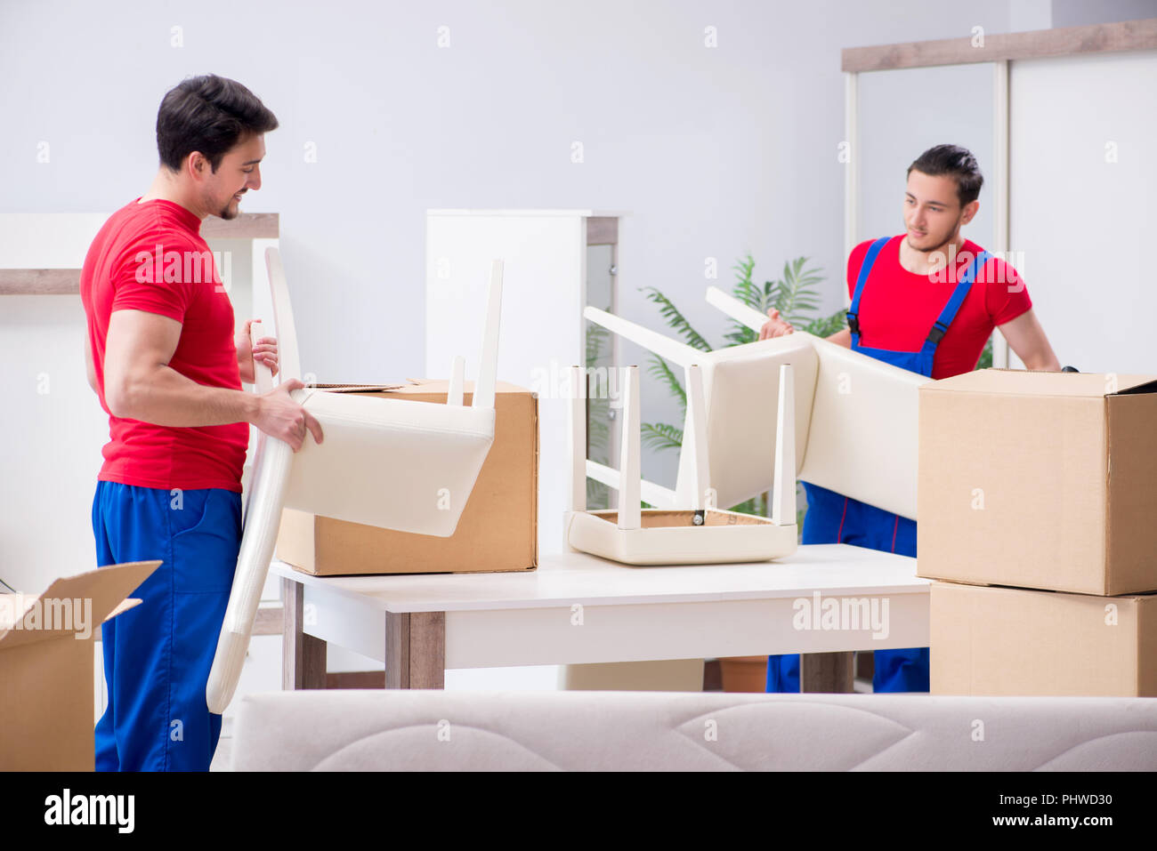 Two contractor employees moving personal belongings Stock Photo - Alamy